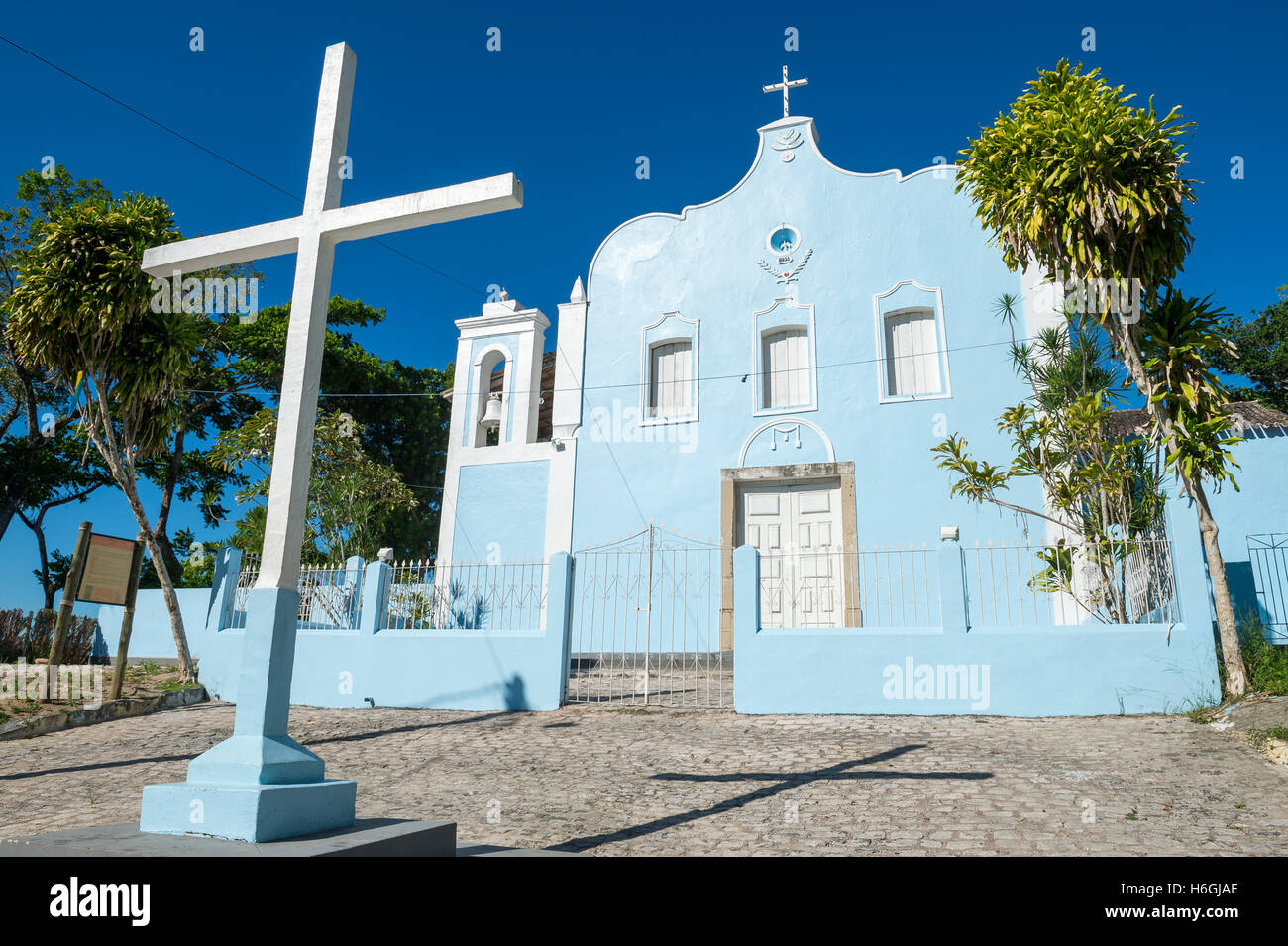 Traditional colonial church architecture with simple Christian cross on ...