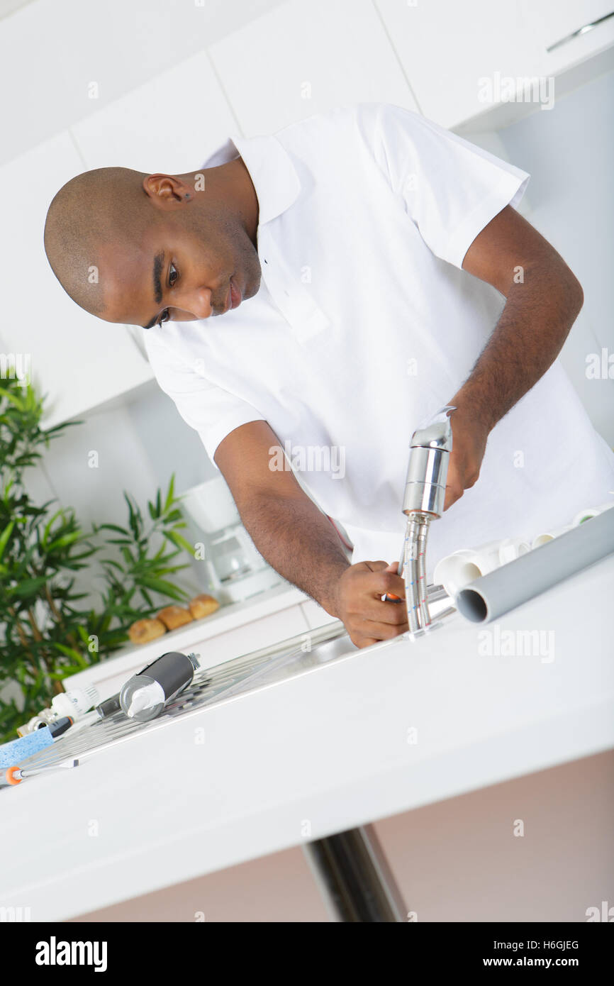 fixing the tap Stock Photo - Alamy