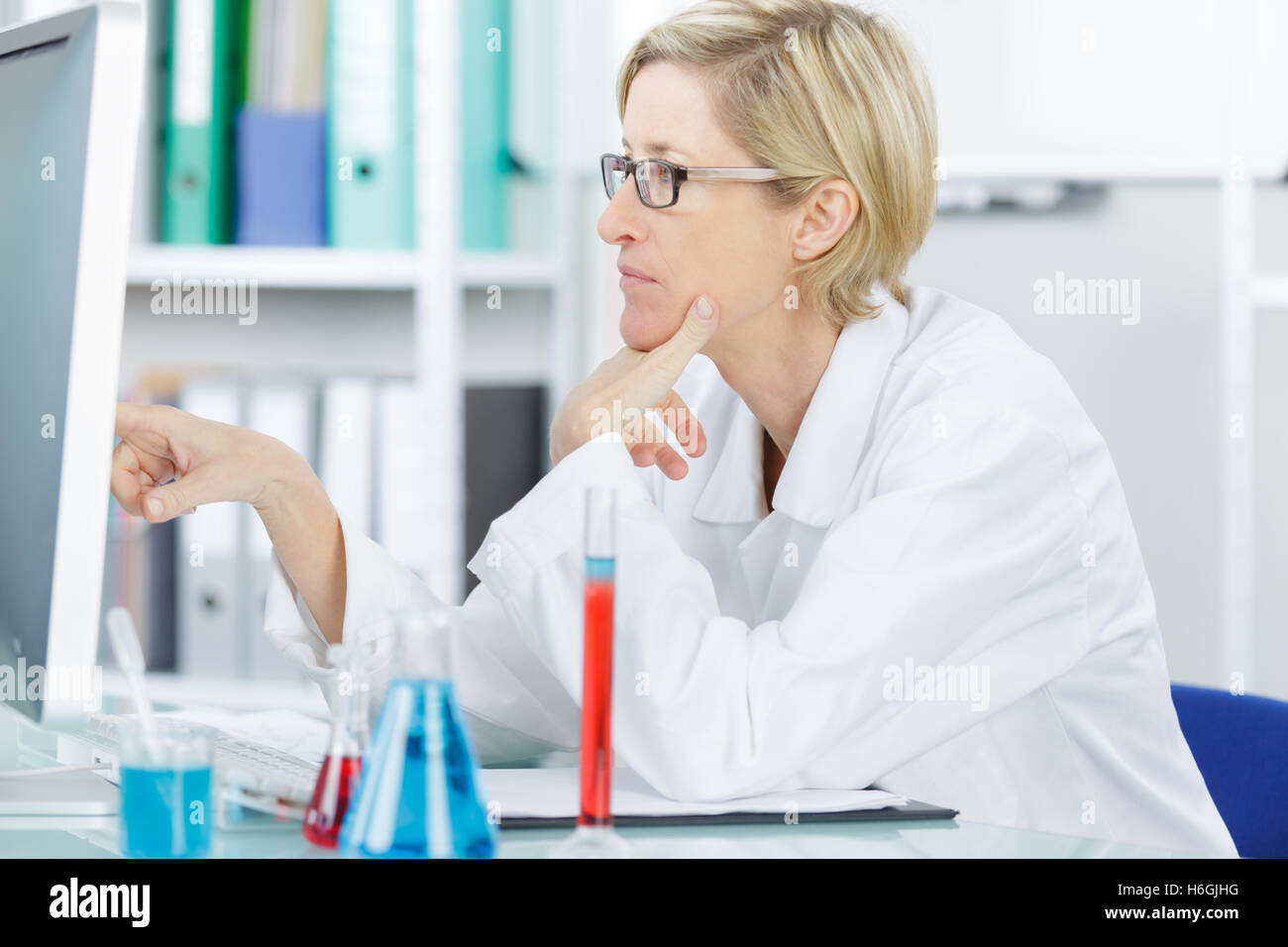 a chemist looking pensively at computer Stock Photo - Alamy