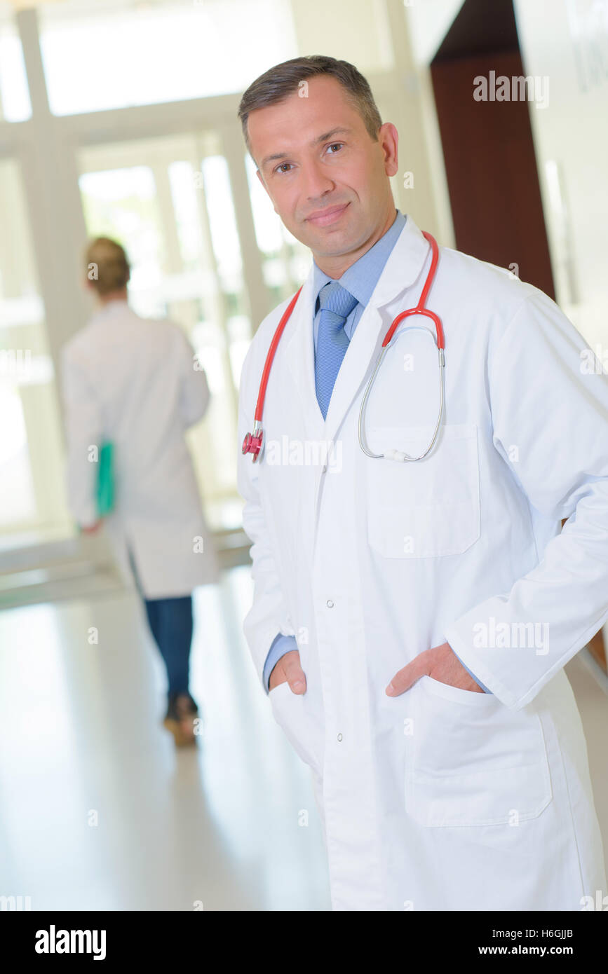 Doctor posing in lobby hi-res stock photography and images - Alamy
