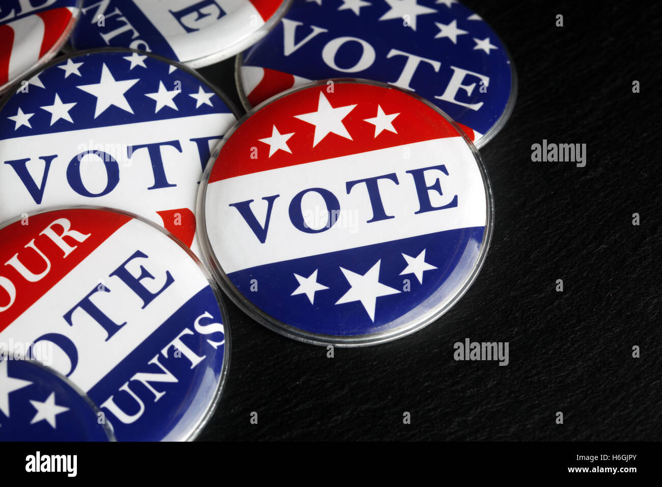 Red, white, and blue vote buttons background Stock Photo - Alamy