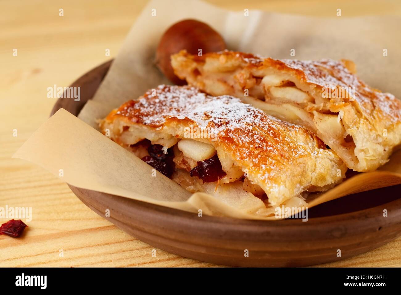 Horizontal photo of two portions of traditional apple pie strudel with ...