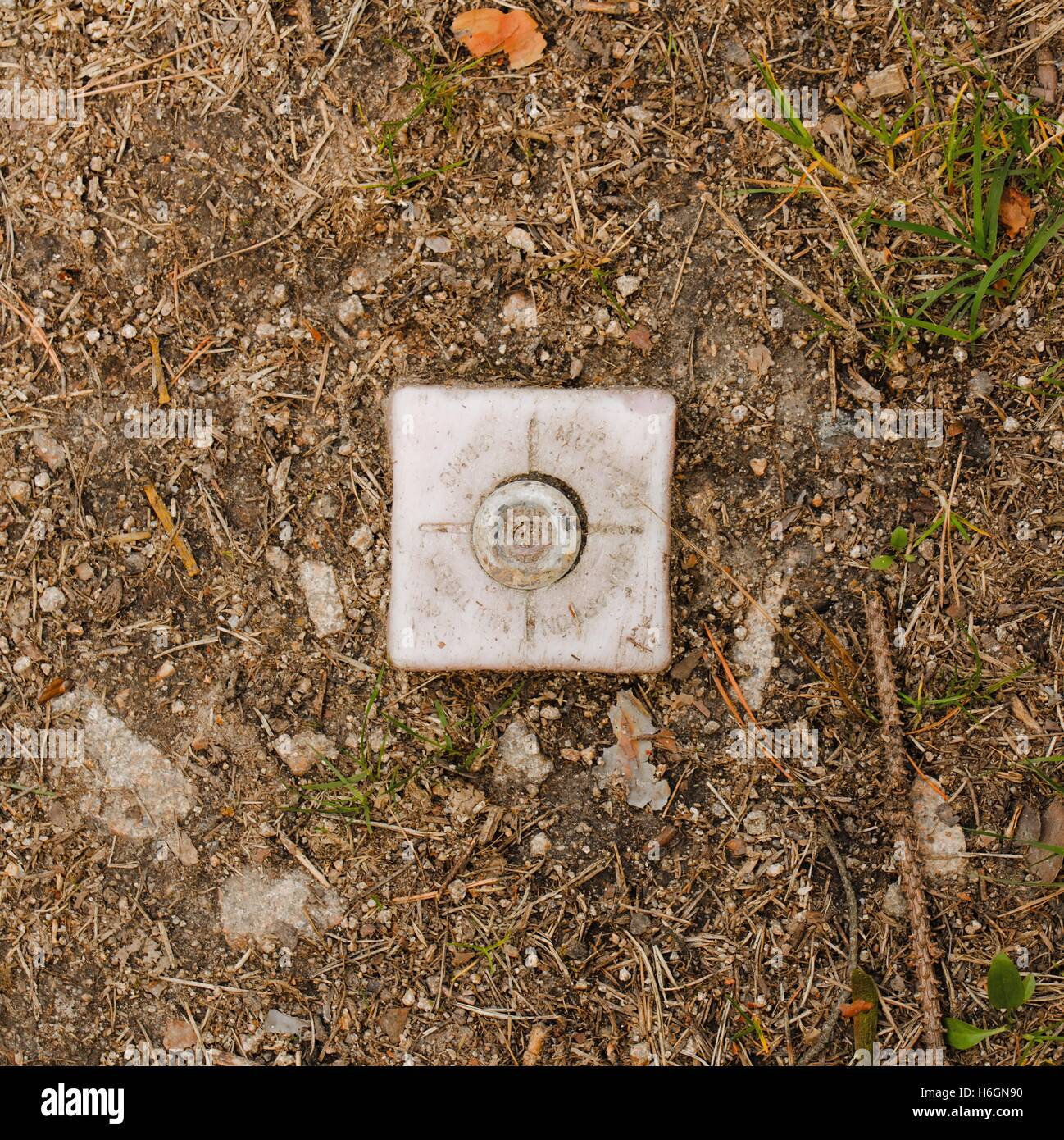 Square photo of border marker. Plastic border marker separating land ...