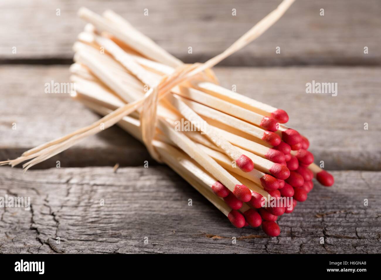 Horizontal photo with Bunch of long wooden matchsticks with red heads ...