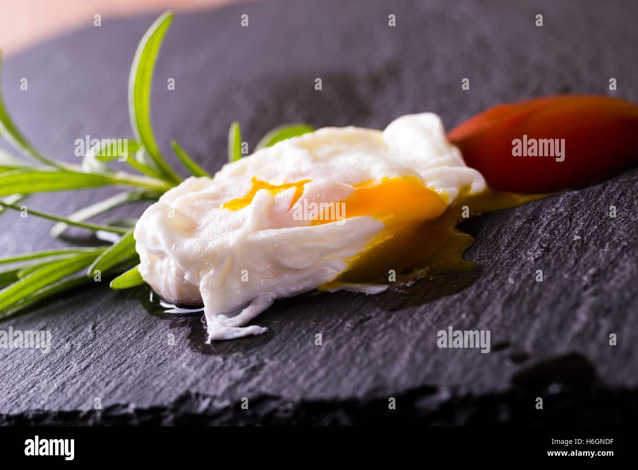 Horizontal photo of single pouched egg with few water bubbles on ...