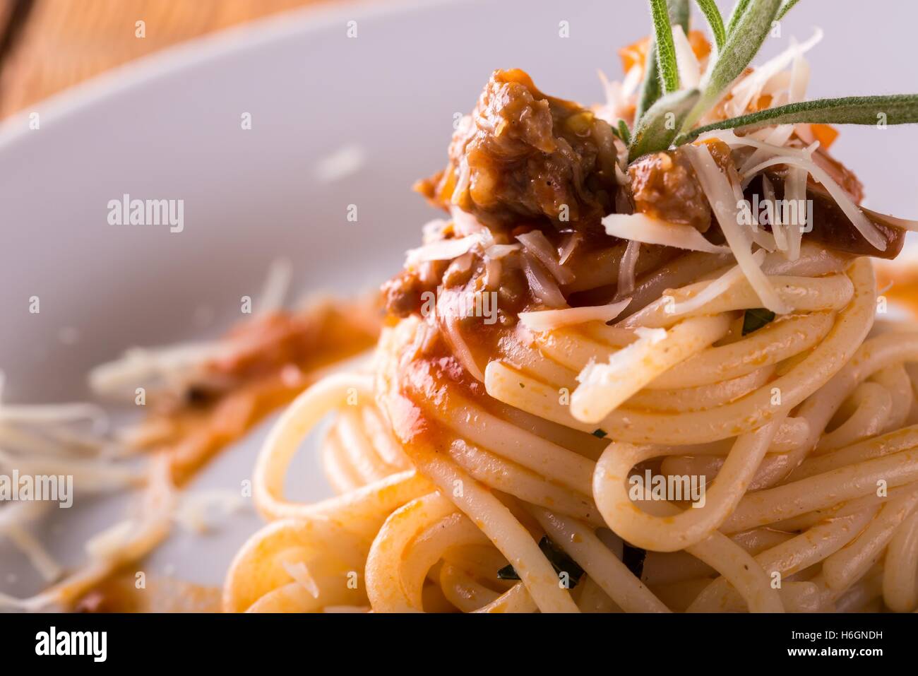 Horizontal photo of single spaghetti portion. Few pieces of minced meat ...