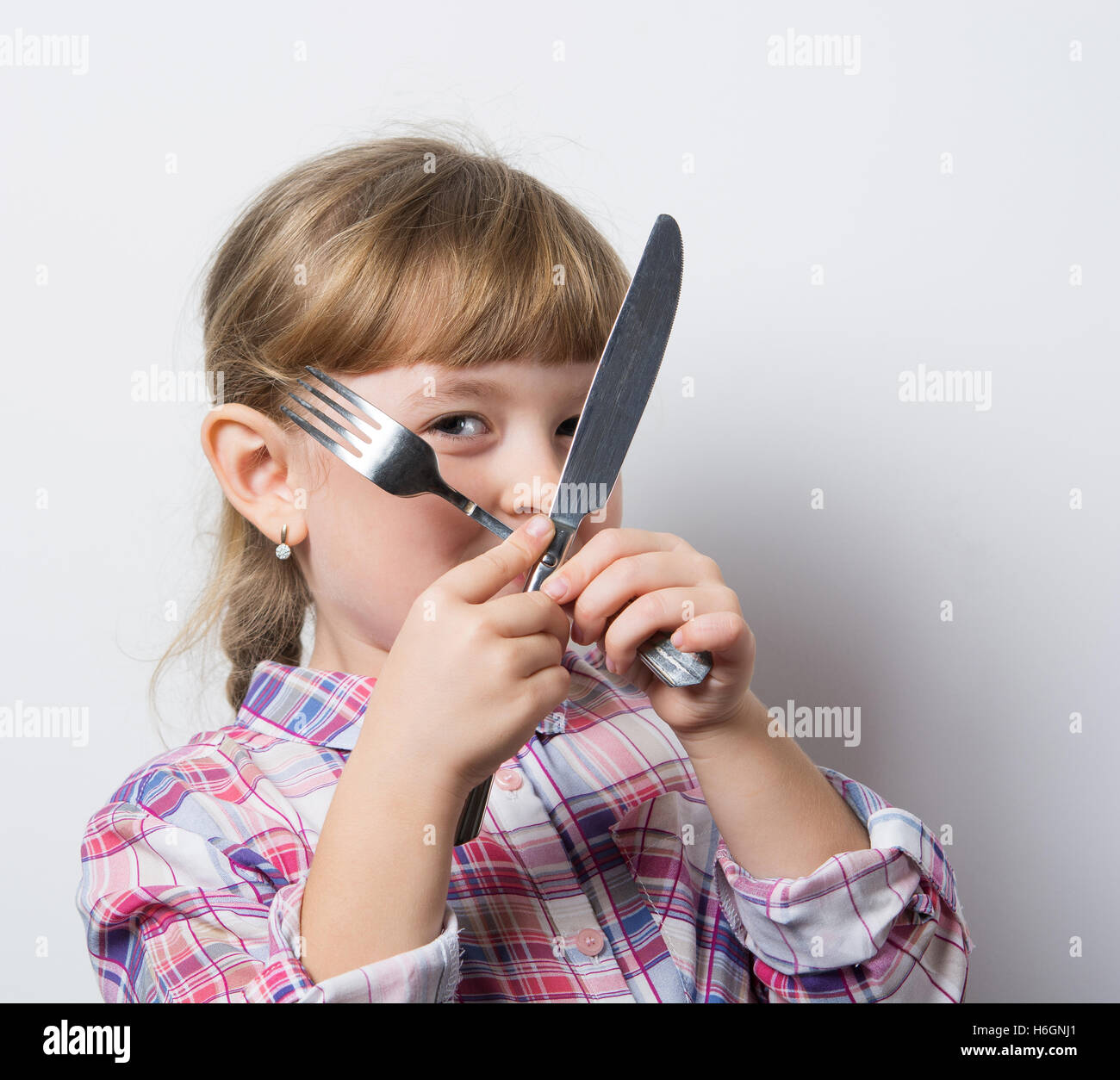 little girl with a knife and fork Stock Photo - Alamy