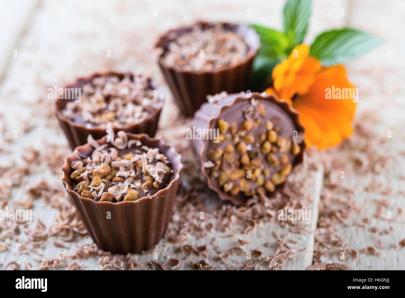 Horizontal photo of few chocolate cupcakes with pistachio nuts which ...