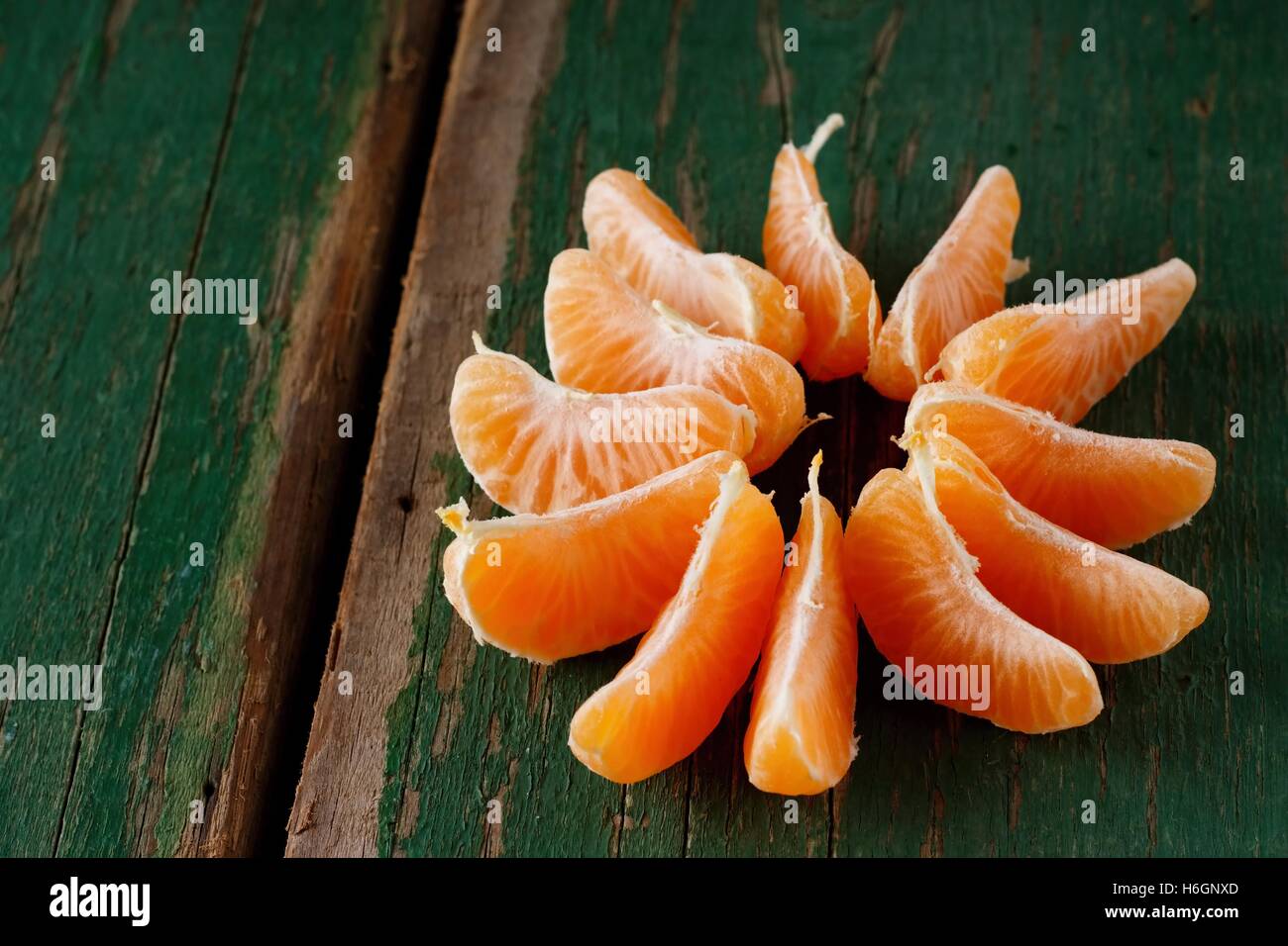 Horizontal photo with single mandarin which was divided to single ...