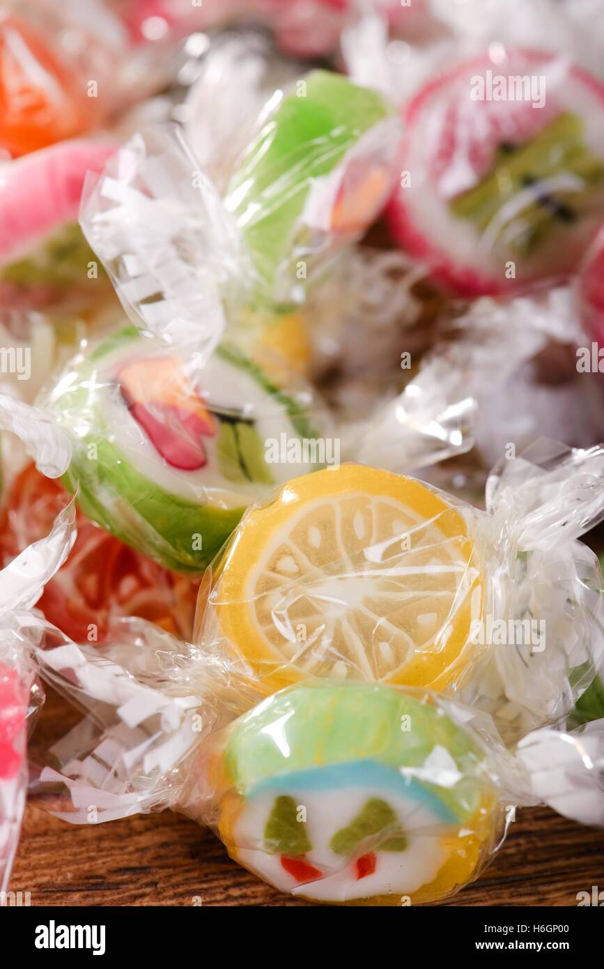 Vertical photo of several candies with fruit taste and fruit motifs ...