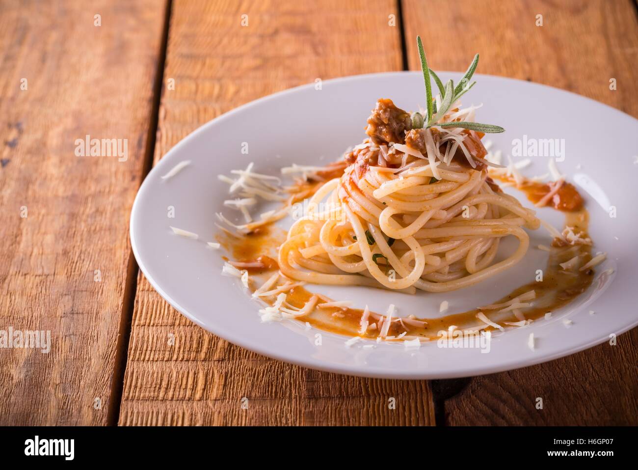 Horizontal photo of single spaghetti portion. Few pieces of minced meat ...