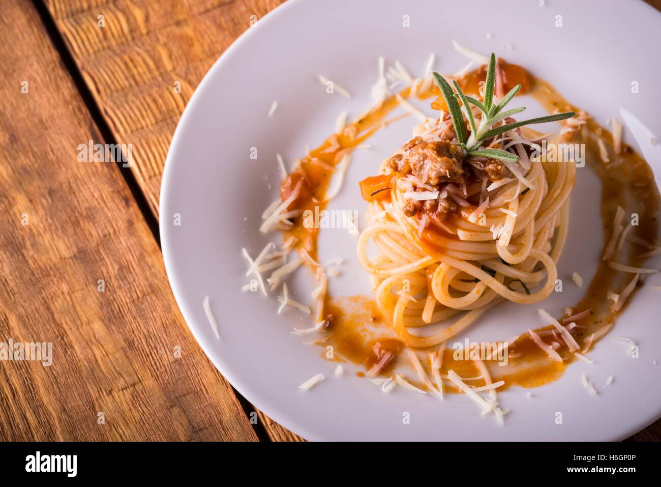 Horizontal photo of single spaghetti portion. Few pieces of minced meat ...