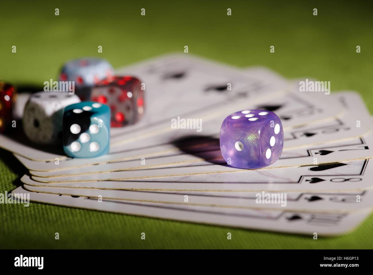 Horizontal photo of used playing cards with flush. Few dices are placed ...