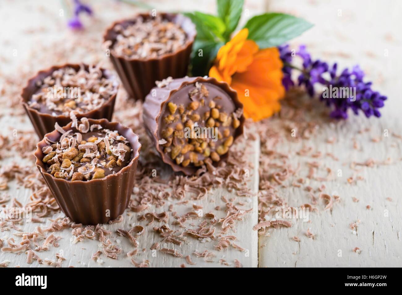 Horizontal photo of few chocolate cupcakes with pistachio nuts which ...