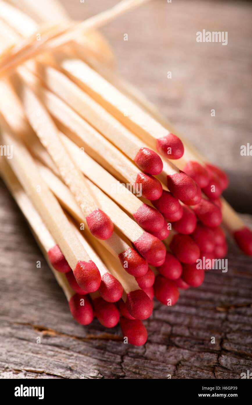 Vertical photo with Bunch of long wooden matchsticks with red heads ...