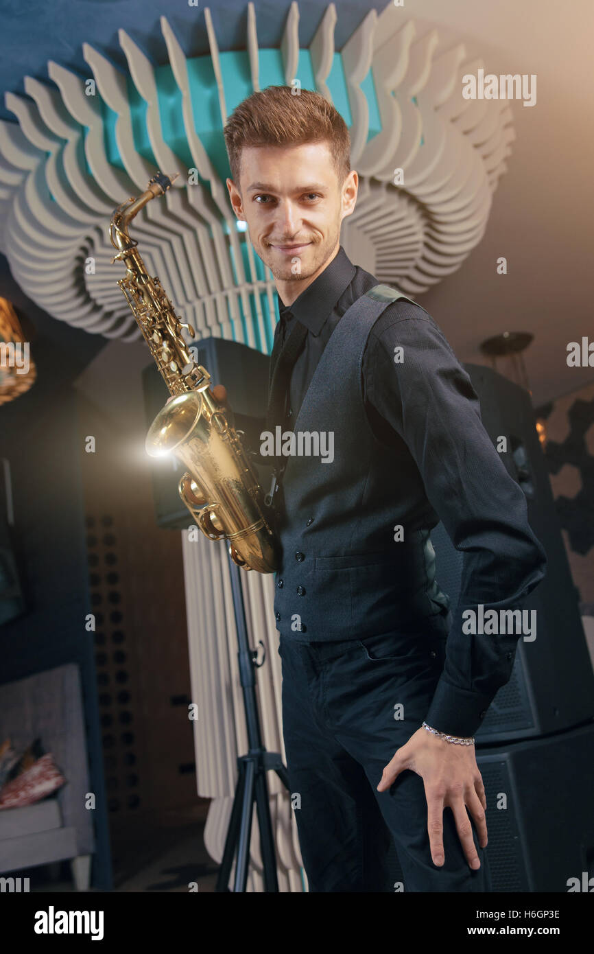 Young man plays a musical instrument saxophone Stock Photo - Alamy