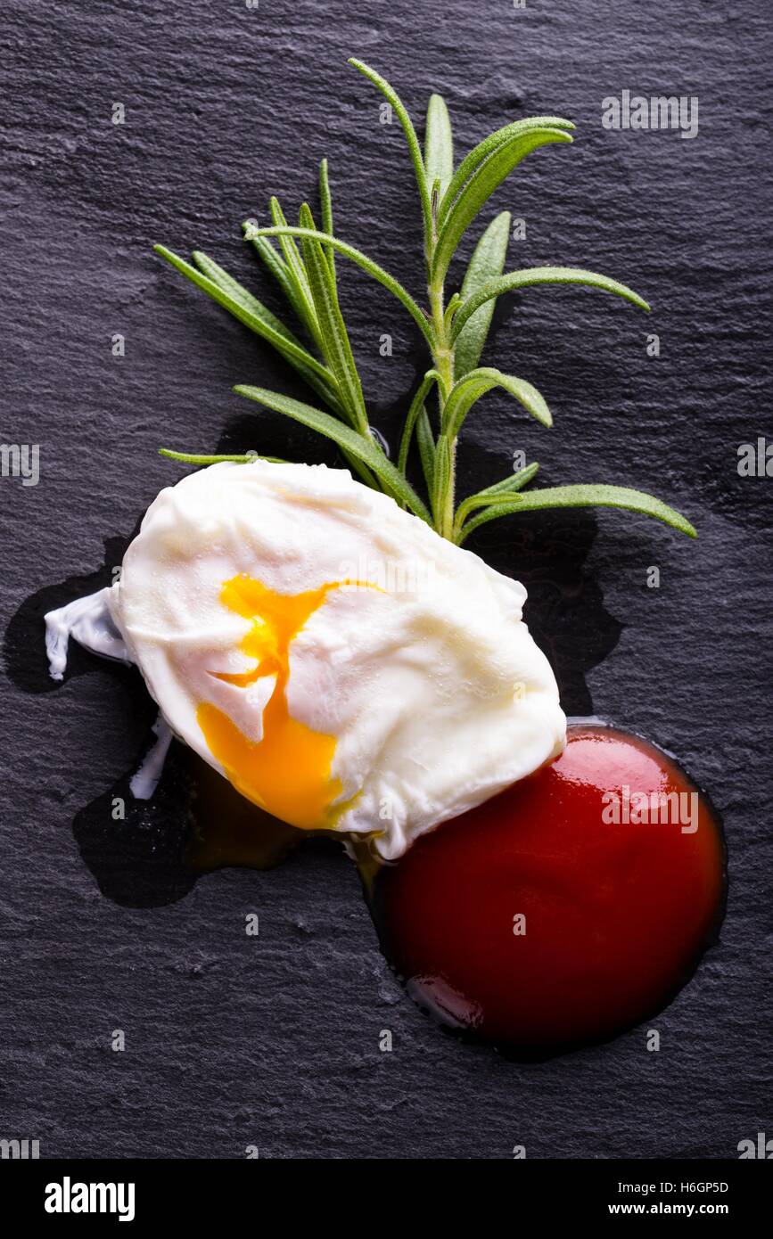 Vertical photo of single pouched egg with few water bubbles on surface ...
