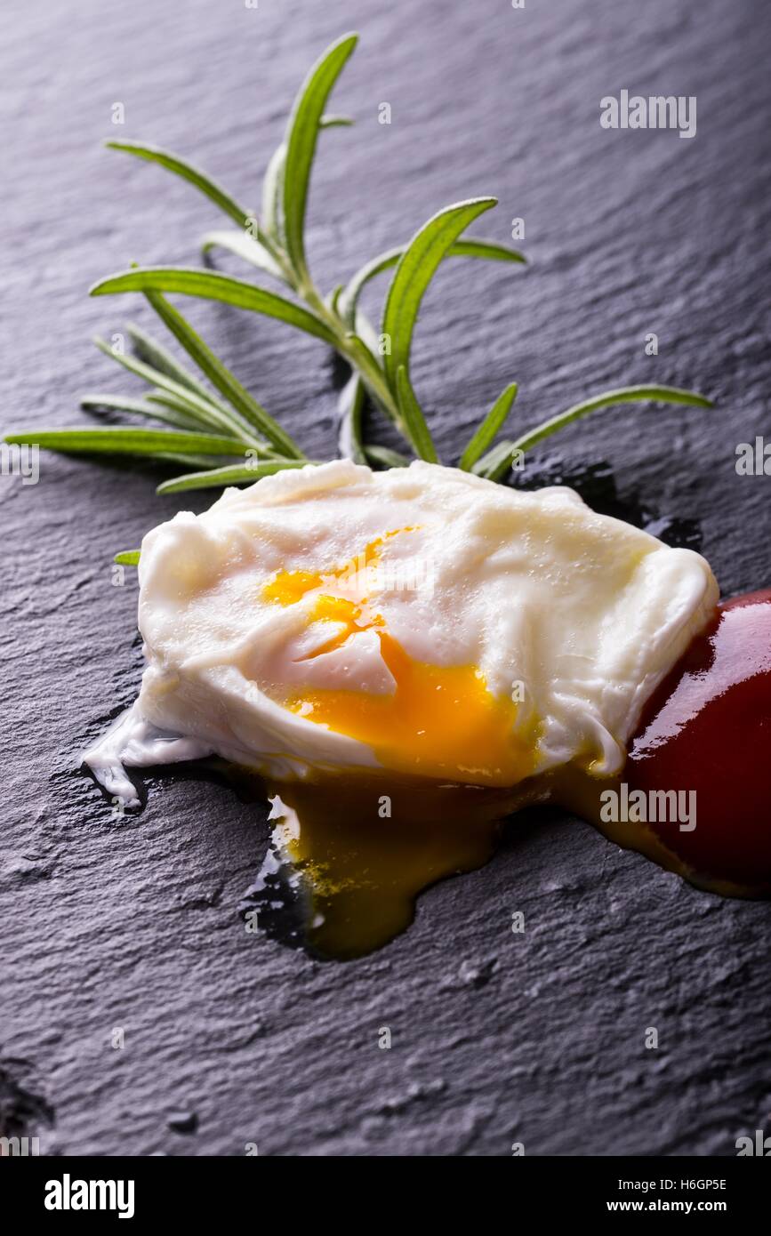 Vertical photo of single pouched egg with few water bubbles on surface ...