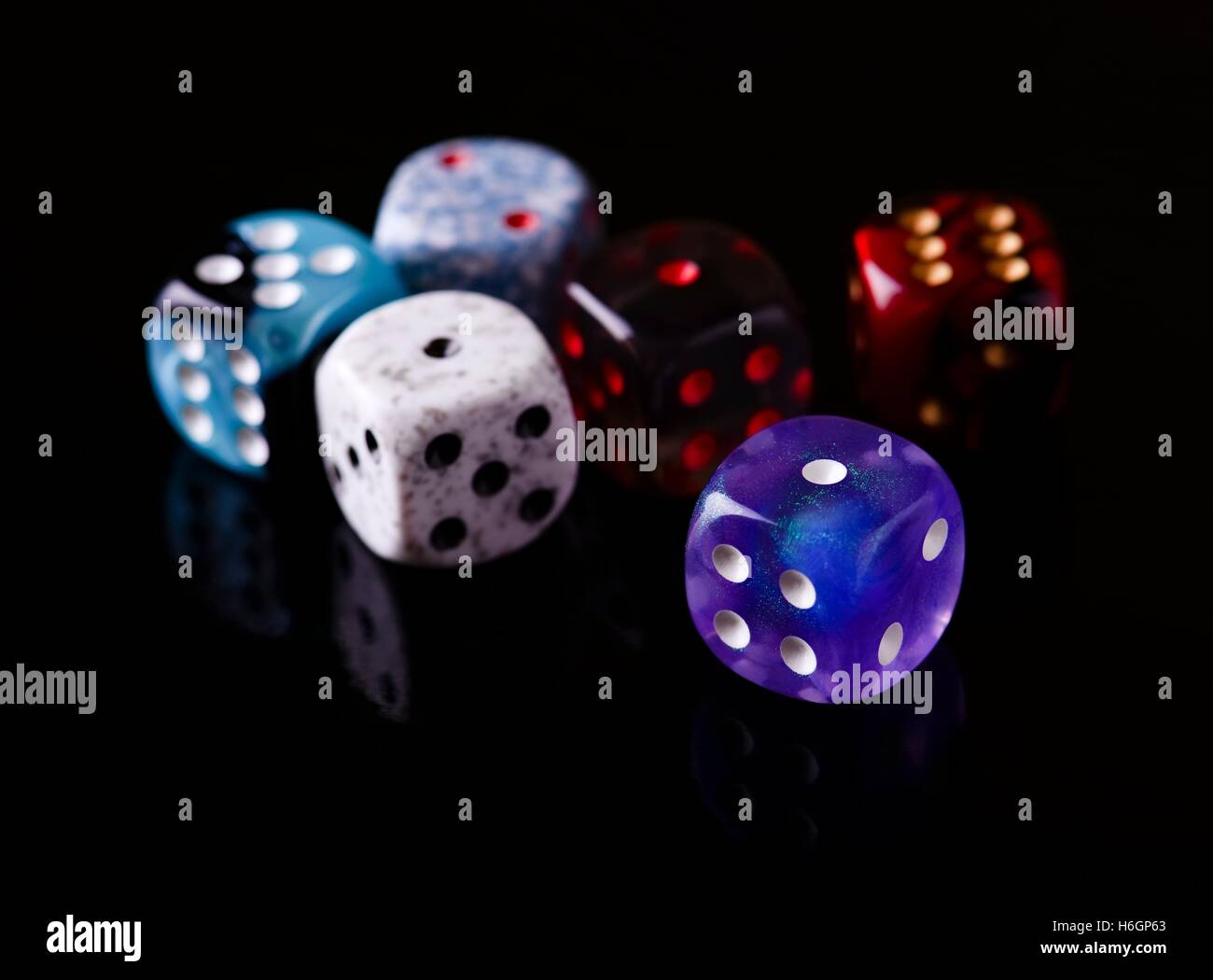 Horizontal photo of six color dices placed on black board with nice ...