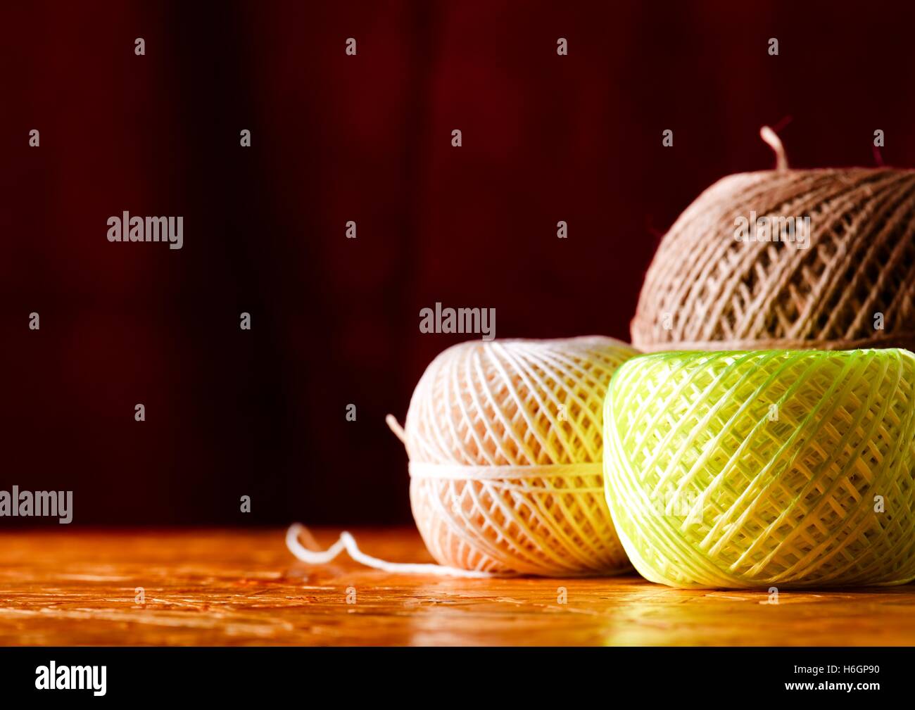 Horizontal photo of three clues of cord with different colors (white ...