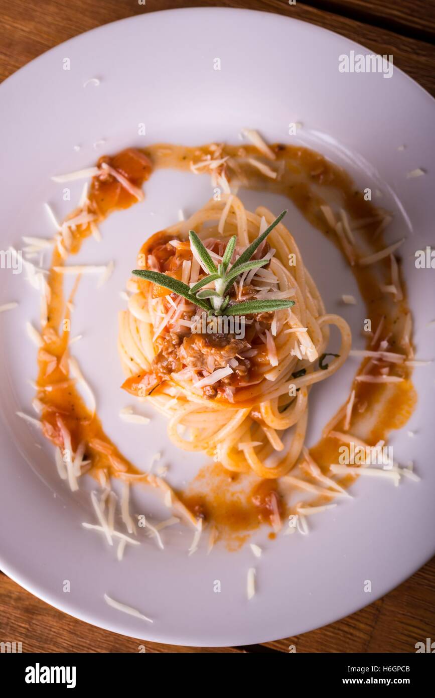 Vertical photo with top view of single spaghetti portion. Few pieces of ...