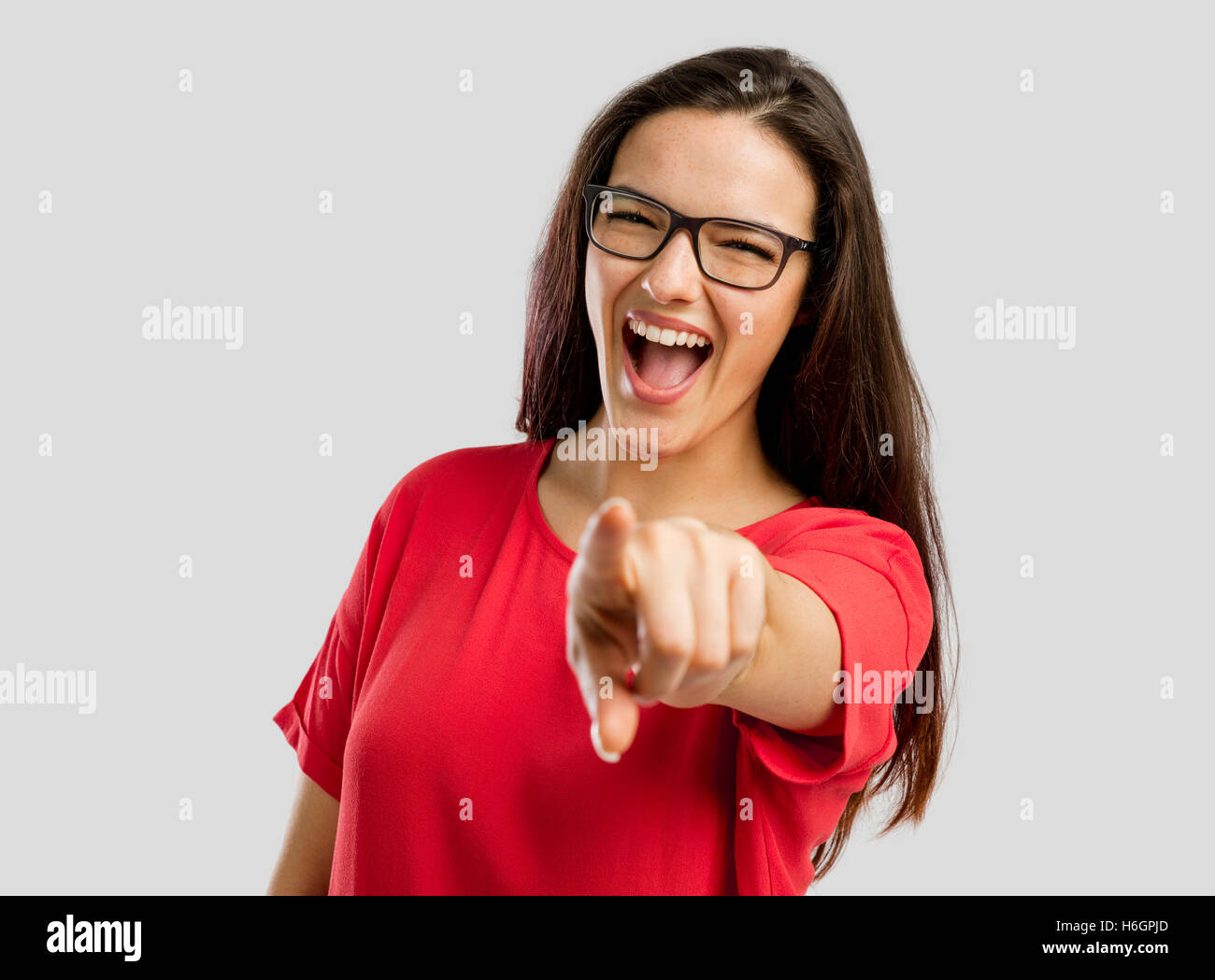 Happy woman smiling and pointing to the camera Stock Photo - Alamy
