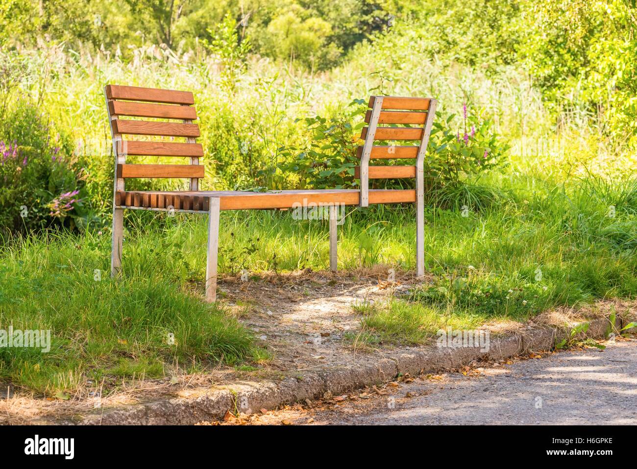Horizontal photo of interesting bench from metal and wood which is ...