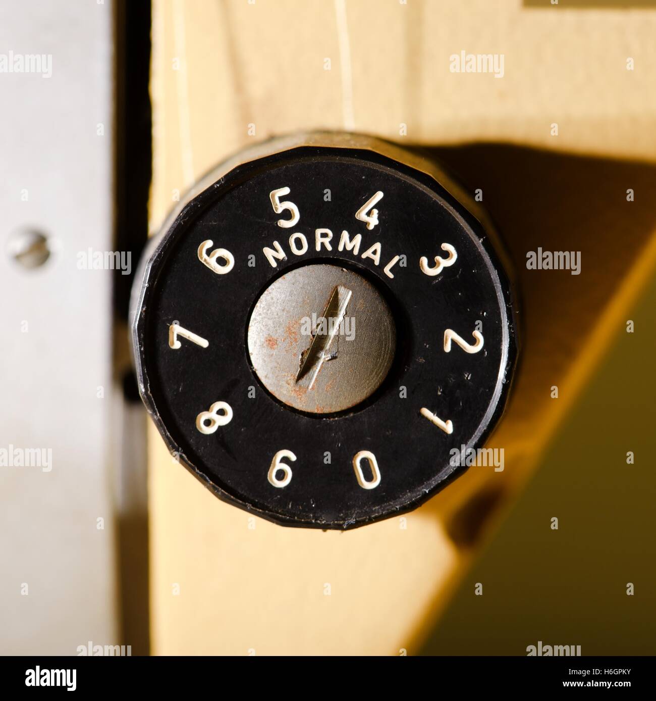 Square photo of old worn plastic control wheel with numbers around and ...