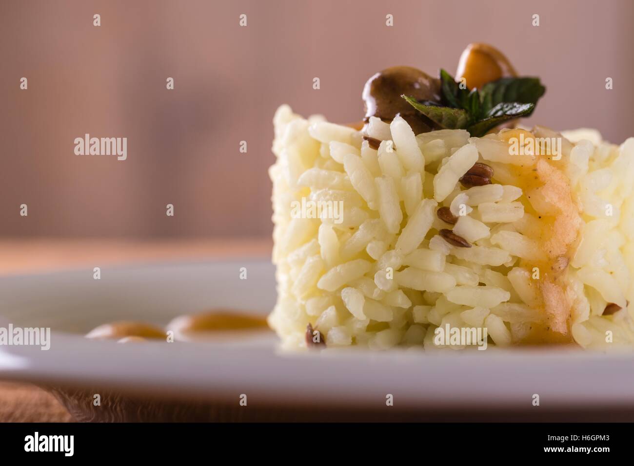 Horizontal photo of yellow curry rise with sesame seeds arranged as a ...