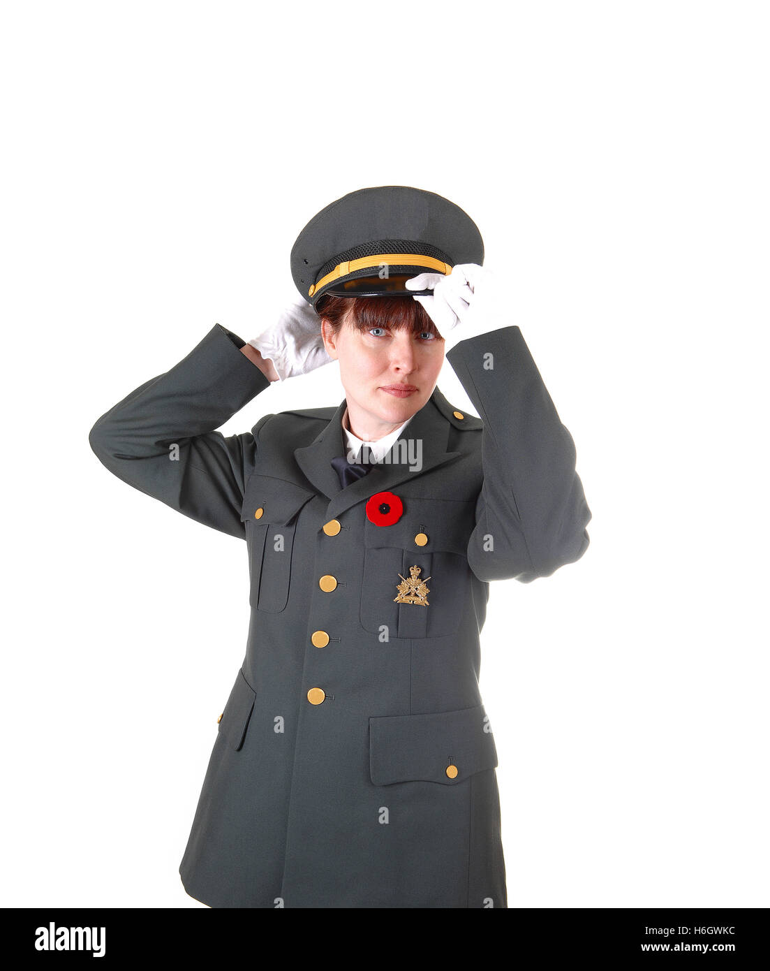 A woman in her forties in a dark olive green uniform standing for white ...