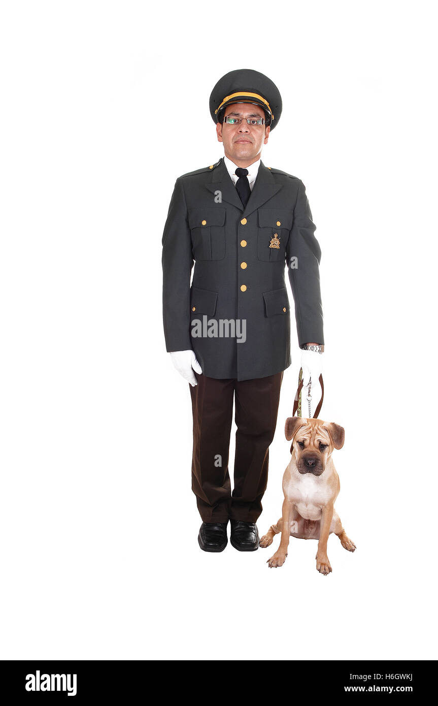 A security guard with his sharpei puppy dog standing in the studio in a ...