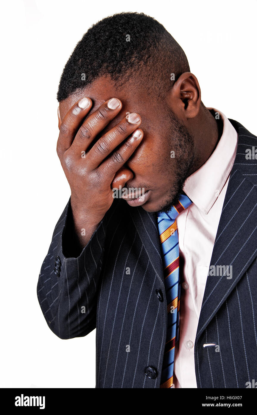 A closeup picture of a black man in a suit, holding his hand on his ...