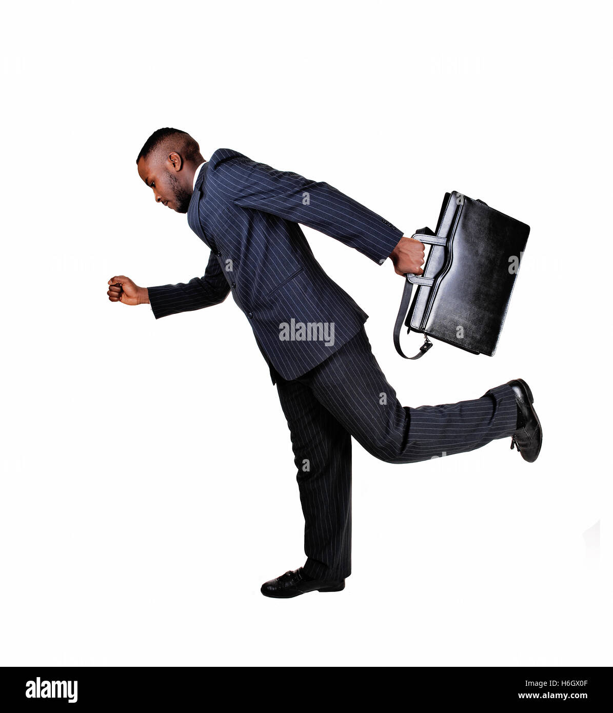 A black business man with his briefcase is running for white background ...