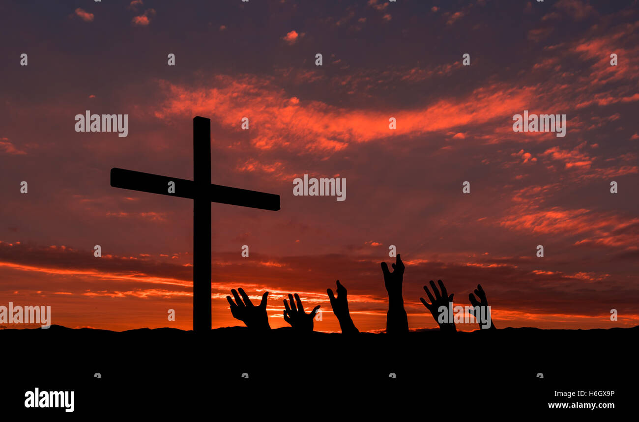 Group of hands reach up to a black cross for salvation Stock Photo - Alamy