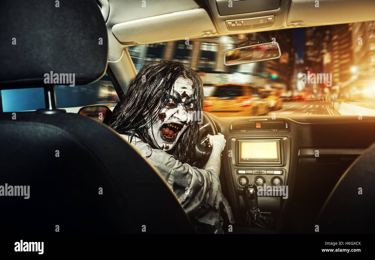 Undead girl with bloody face rides in the car Stock Photo - Alamy