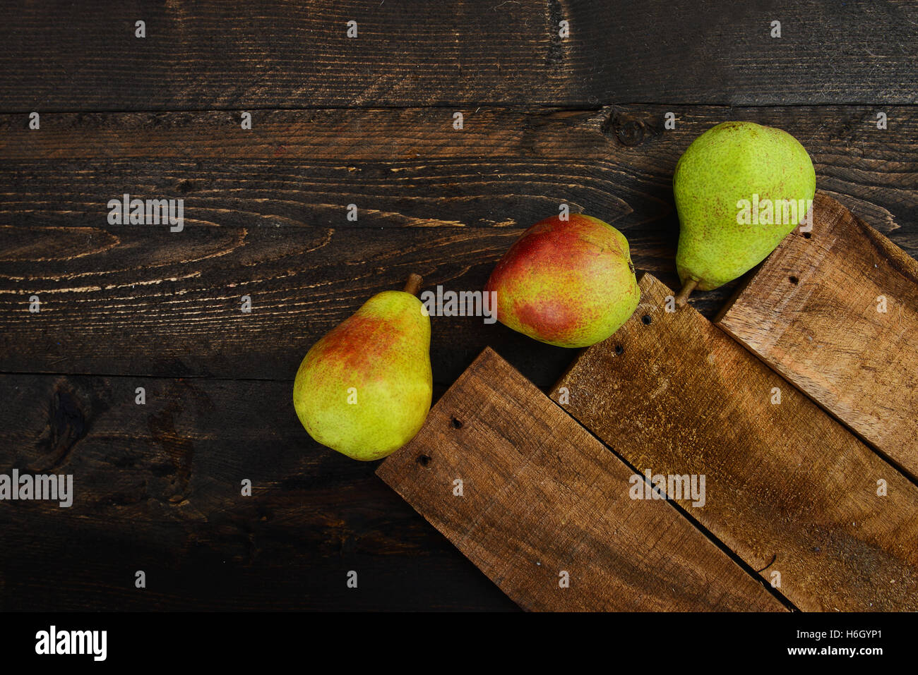 Pears on a rustic wooden kitchen table Stock Photo - Alamy