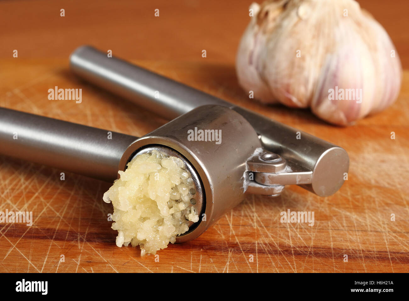 Garlic crushed with garlic press Stock Photo - Alamy