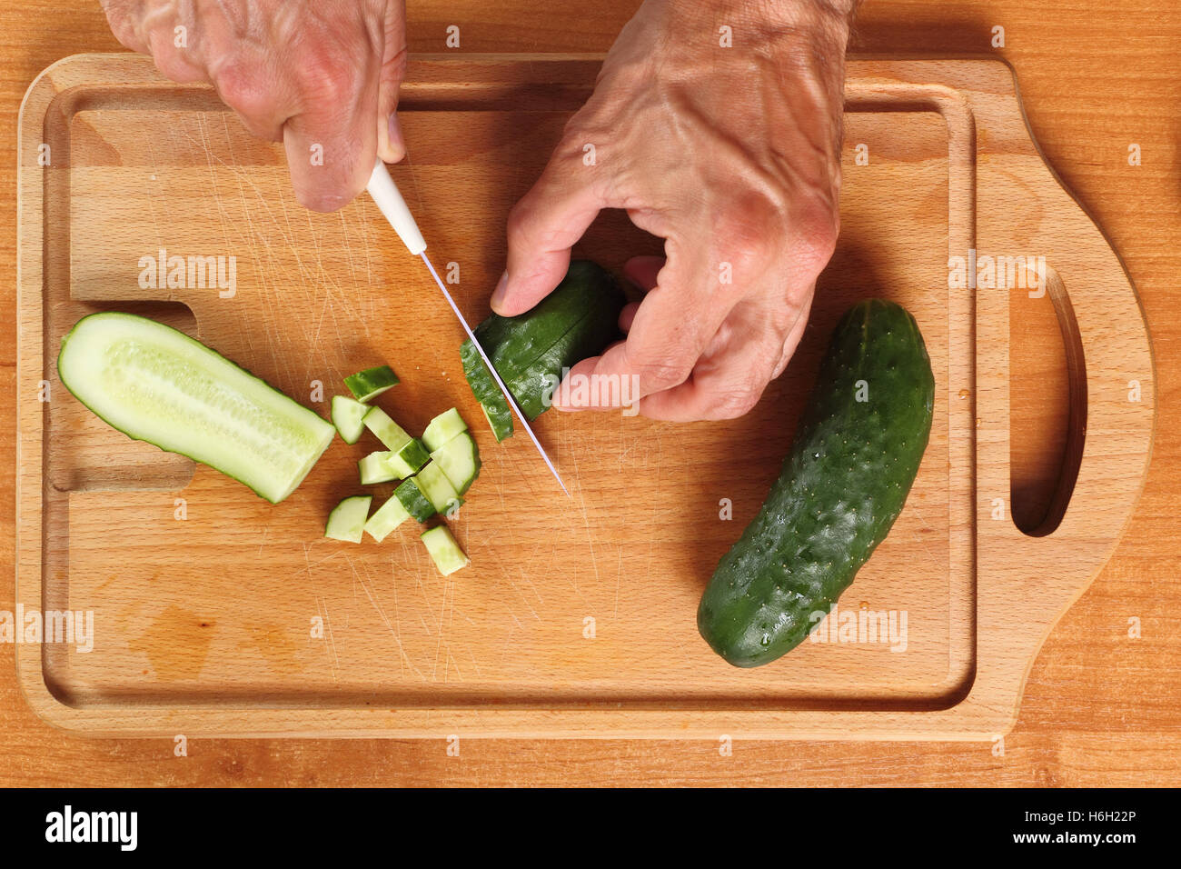 Dicing cucumber. Directly Above Stock Photo - Alamy