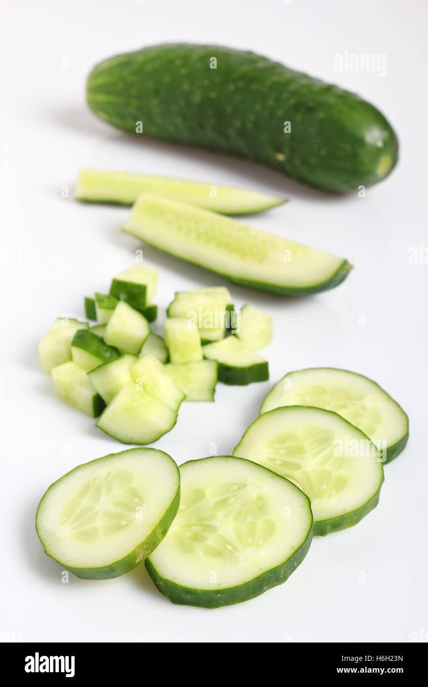 Slicied and diced cucumbers. Isolated on a white background Stock Photo ...