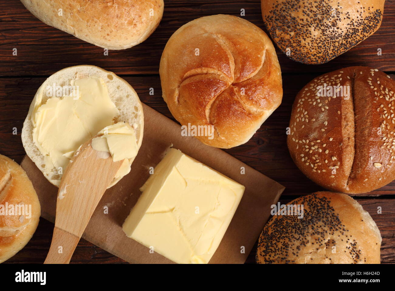 Spreading butter on bread roll. Directly Above Stock Photo - Alamy