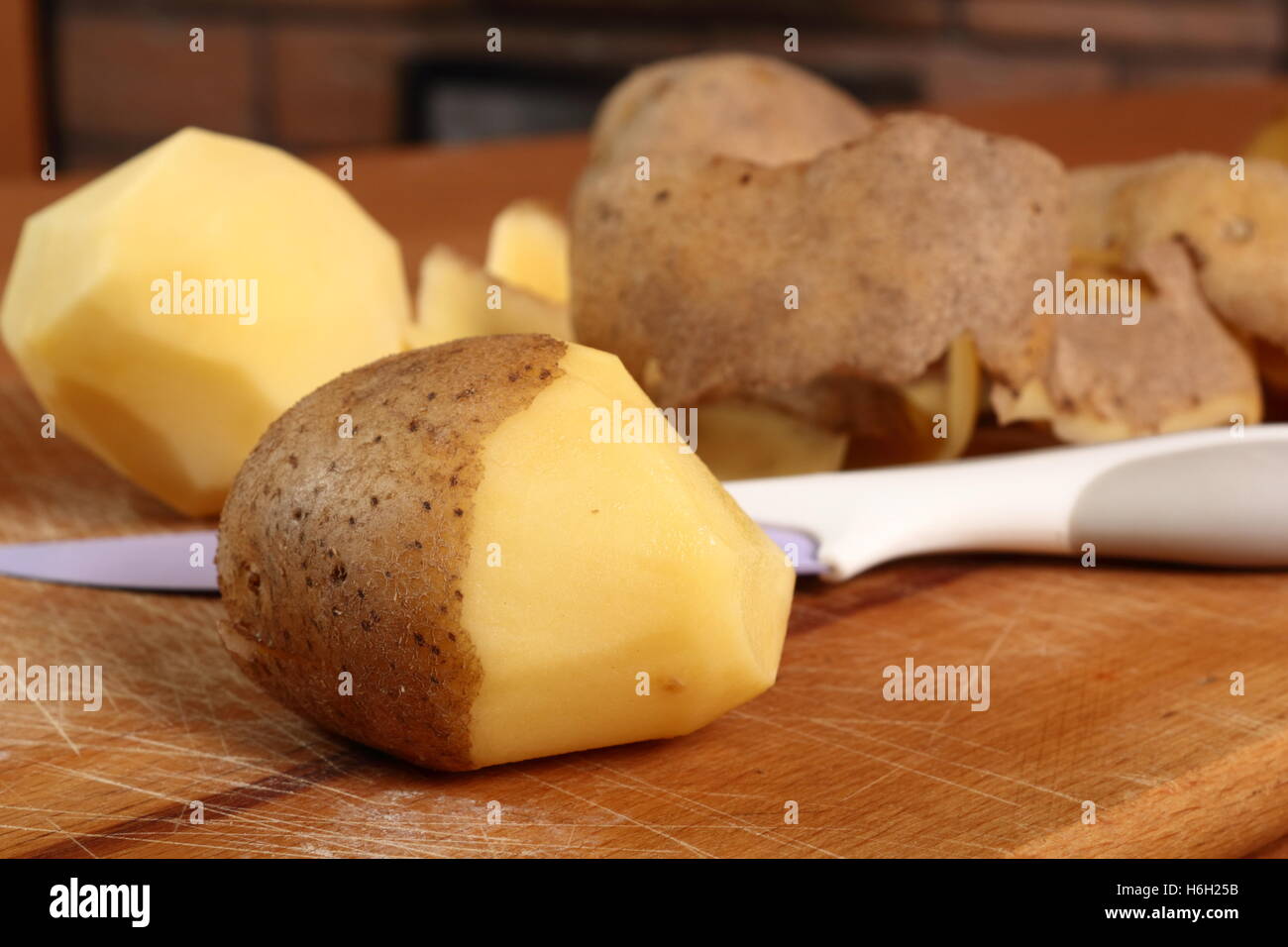 Half peeled potatoes Stock Photo - Alamy