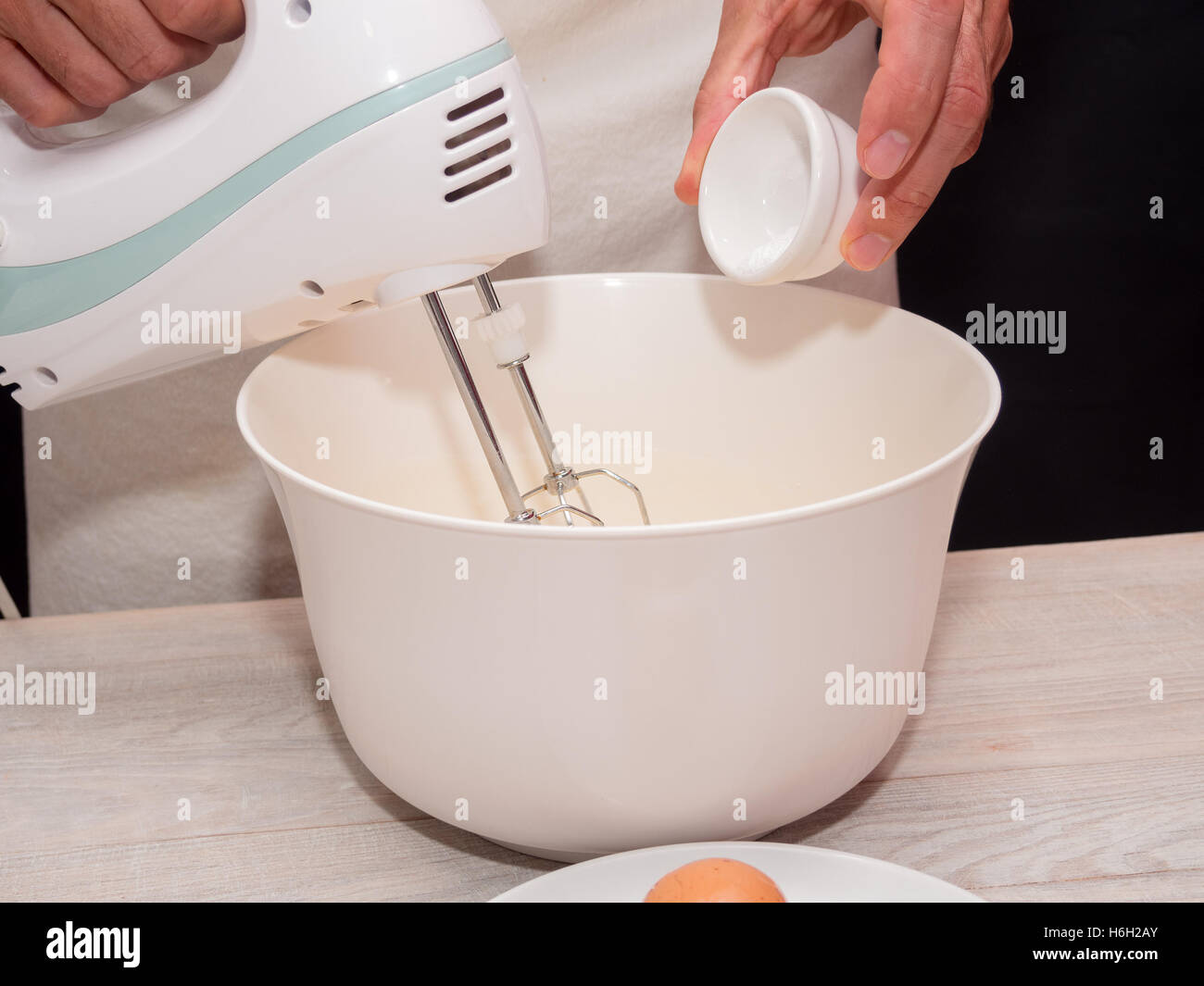 Adding baking powder. Making Yogurt Cake Stock Photo - Alamy