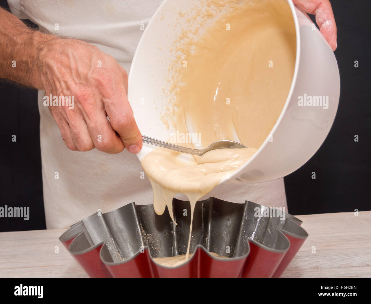 Man pouring batter into cake tin hi-res stock photography and images ...