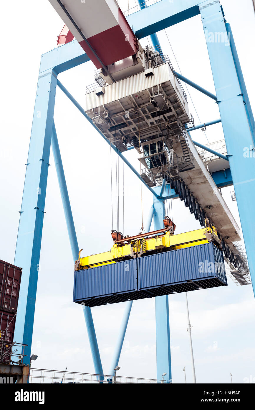 View of a freighter ship being loaded by a crane with containers at a ...