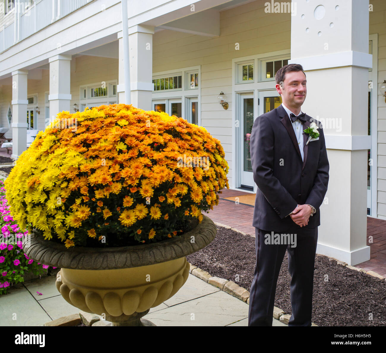 Happy smiling groom waiting for bride for wedding photographs; Omni ...
