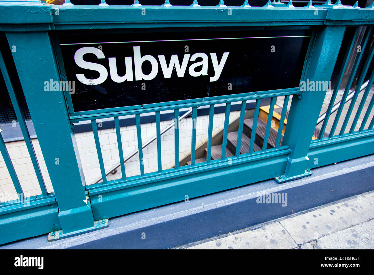 Sign depicting that the staircase behind it is an entrance to a subway ...