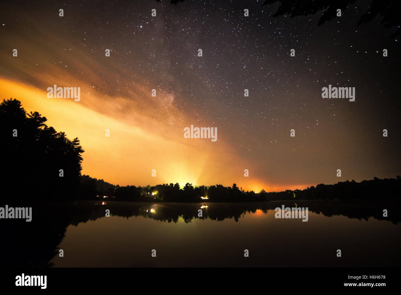 Light pollution from city at night over lake Stock Photo - Alamy
