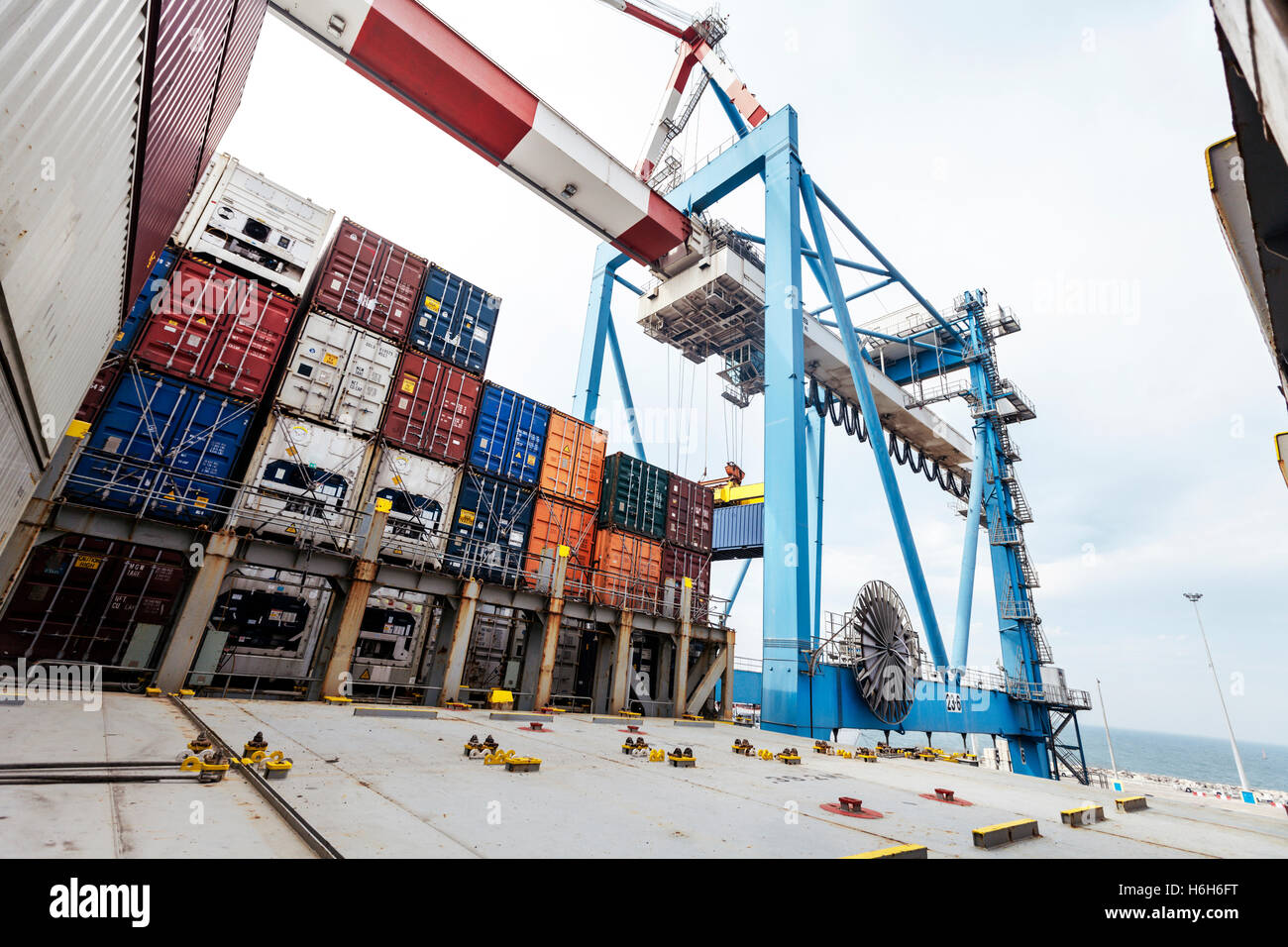 View of a freighter ship being loaded by a crane with containers at a ...