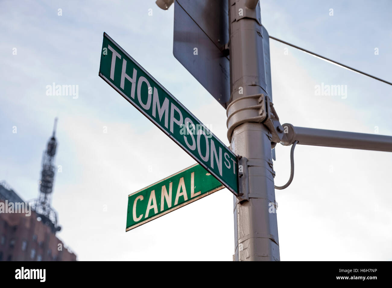 Street sign depicting it is the crossing of Thompson St. with Canal St ...