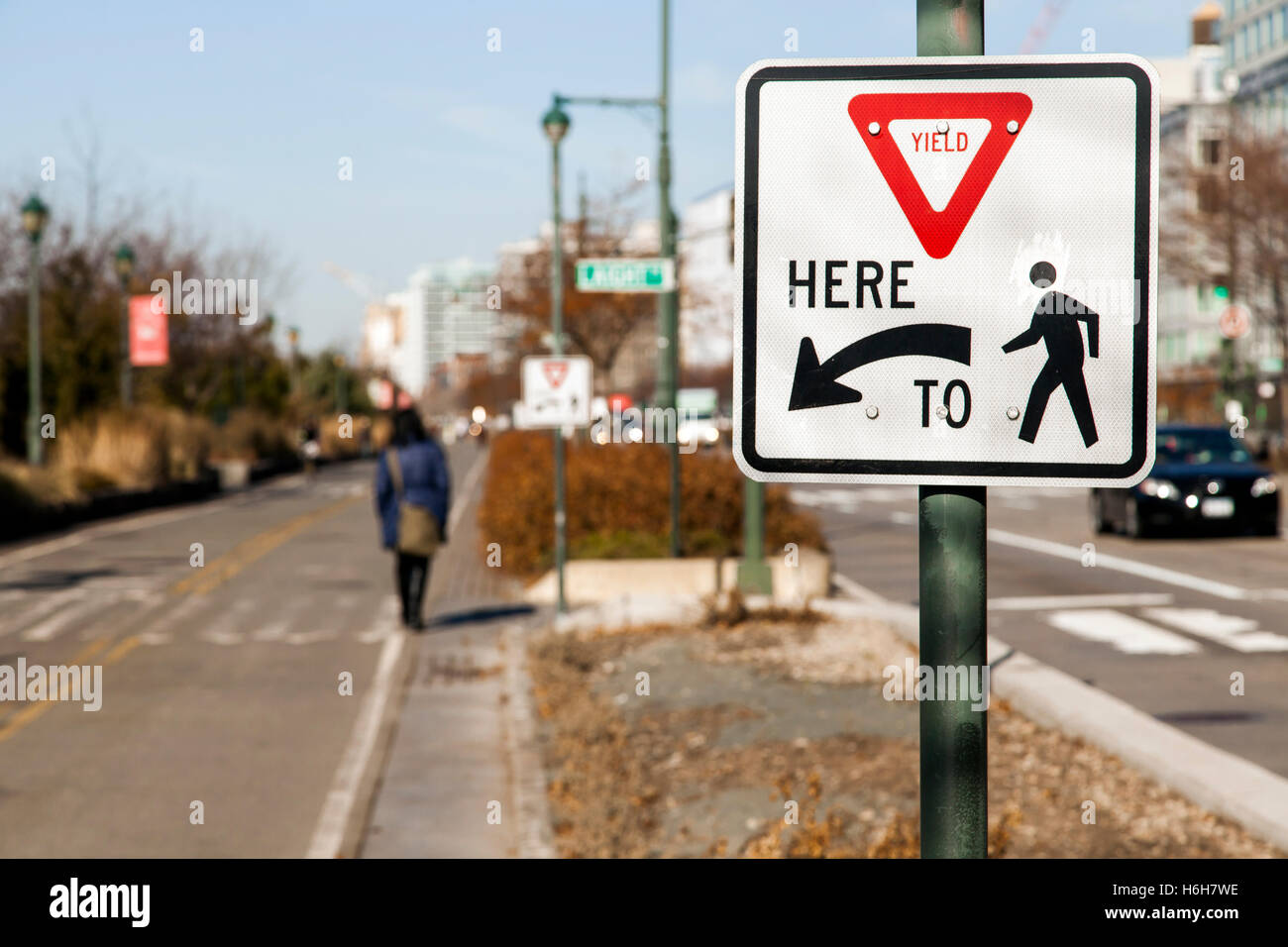 Sign pointing pedestrians where to go Stock Photo - Alamy